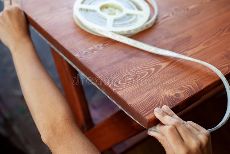 Installing Led Strip Lighting for Under Wooden Table Stock Photo ...