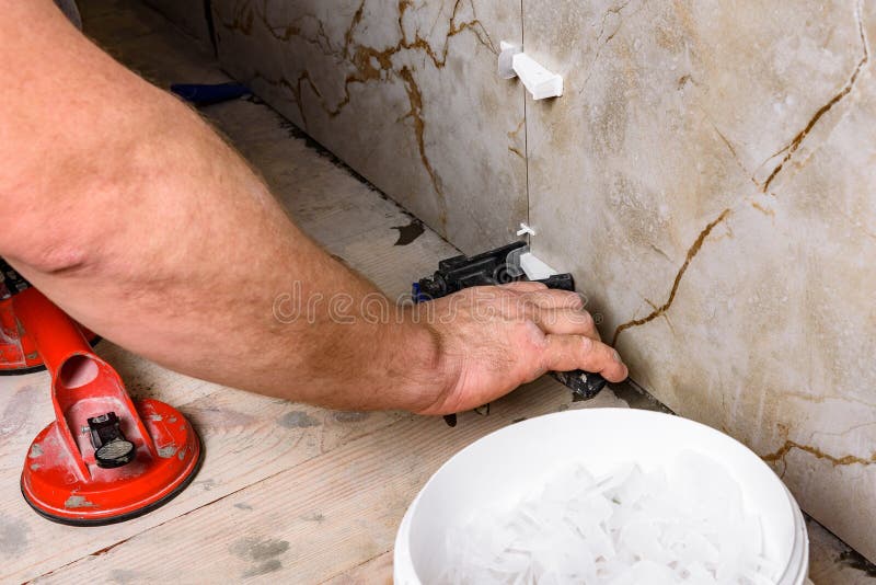 Installing Leveling System Tiles Using Black Tongs. Stock Photo - Image ...