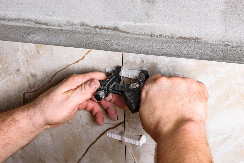 Installing Leveling System Tiles Using Black Tongs. Stock Image - Image ...