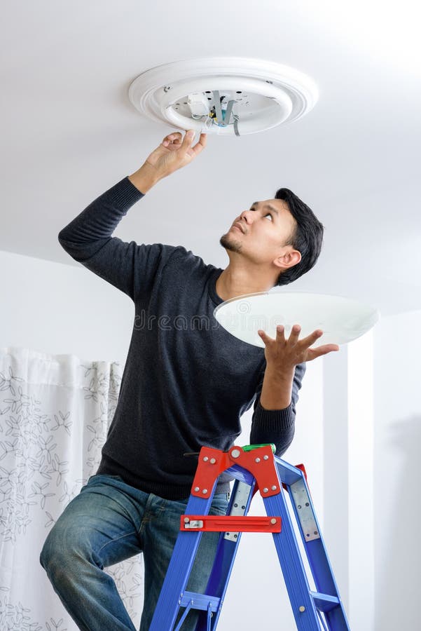 Installing light bulb stock image. Image of technician - 167102951