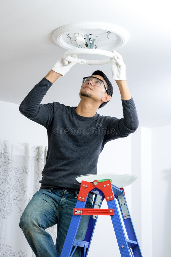 Installing light bulb stock image. Image of husband - 167103029