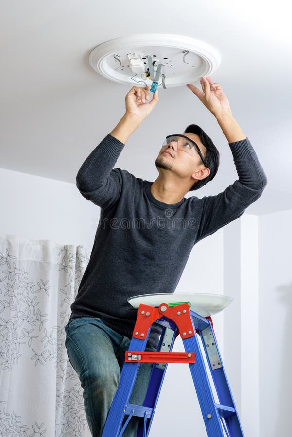 Installing light bulb stock photo. Image of asian, labor - 167103190
