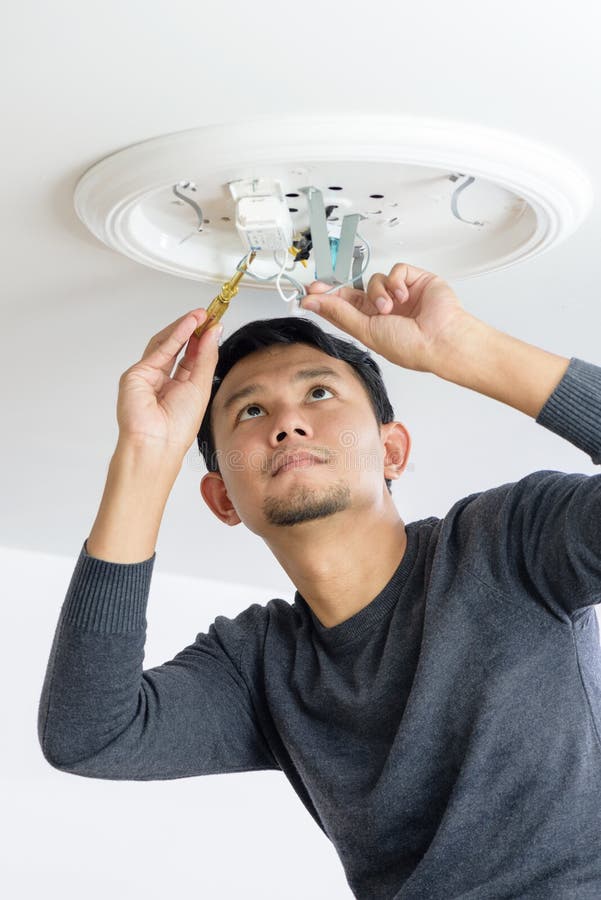 Installing light bulb stock photo. Image of asian, labor - 167103190