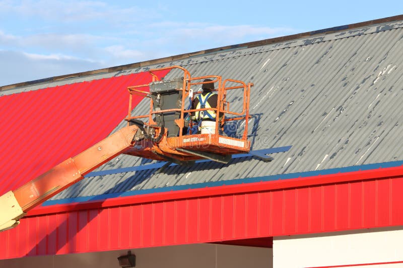 Installing a Metal Roof editorial stock photo. Image of professional ...
