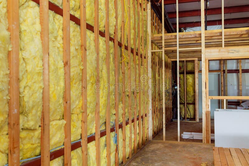 Installing Mineral Rock Wool Insulation To Walls during New a ...