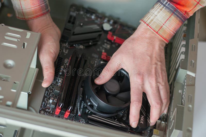 Installing a New Motherboard in the System Unit. Close-up of the Hands ...