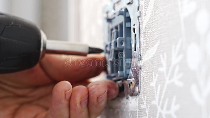 Installing a New Switch with a Drill for Electrical Services Stock ...