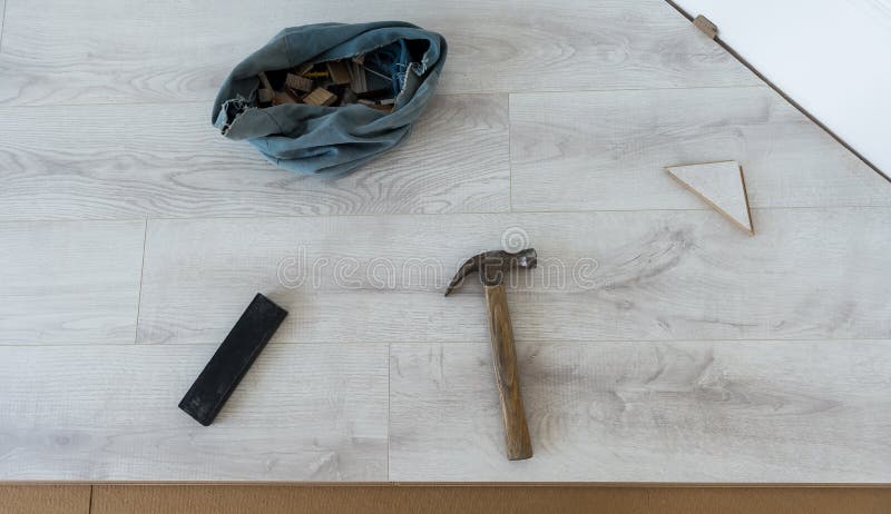 Installing New White Laminated. Worker Tools on Wooden Floor Stock ...