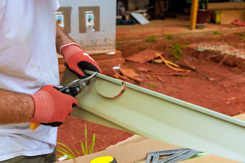 Before Installing Plastic Vinyl Siding, Worker Uses a of Scissors To ...
