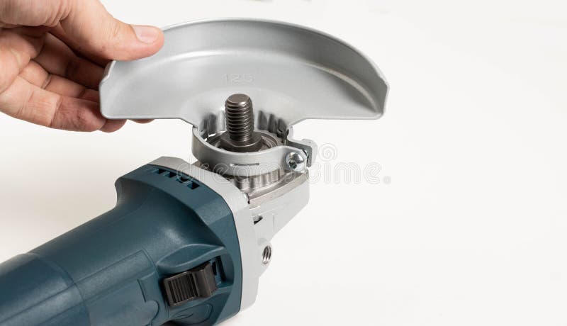 Installing the Safety Cover on an Angle Grinder, Close-up. Safety ...