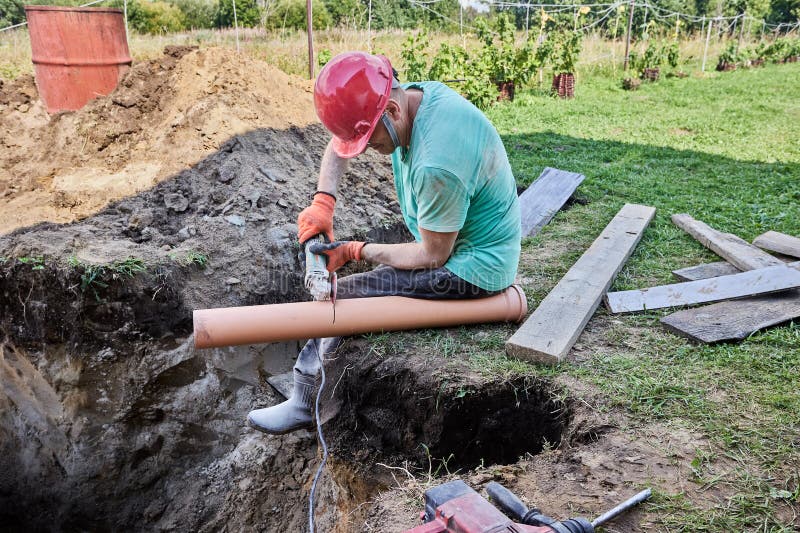 Worker Uses an Abrasive Wheel on an Angle Grinder To Cut Off Section of ...