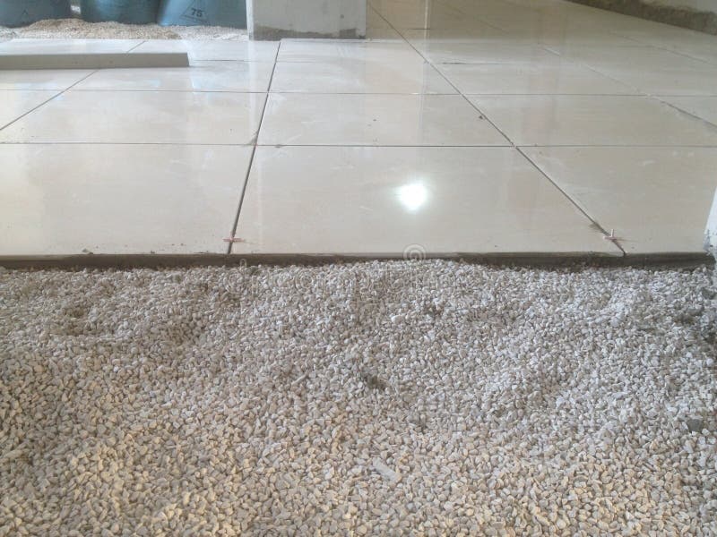 Installing tails.. stock image. Image of flooring, cream - 125909425