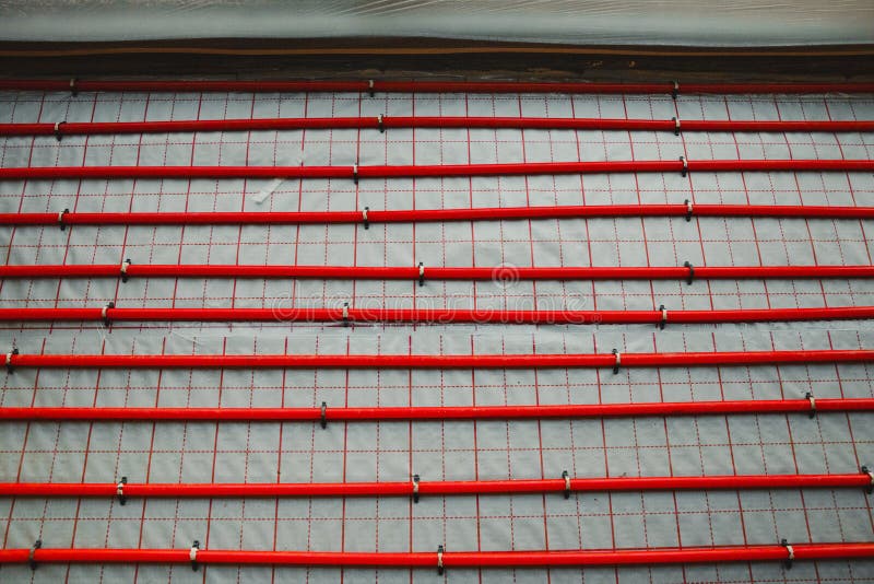 Installing Underfloor Heating System with Red Pipes on Insulation ...