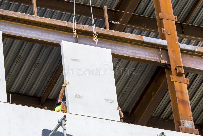 Installing a Wall Panel on the Exterior of a Building Under ...