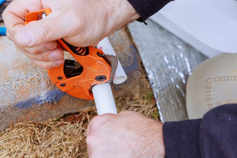 When Installing Water Pipe, Plumber Cuts a Plastic PVC Pipe with ...