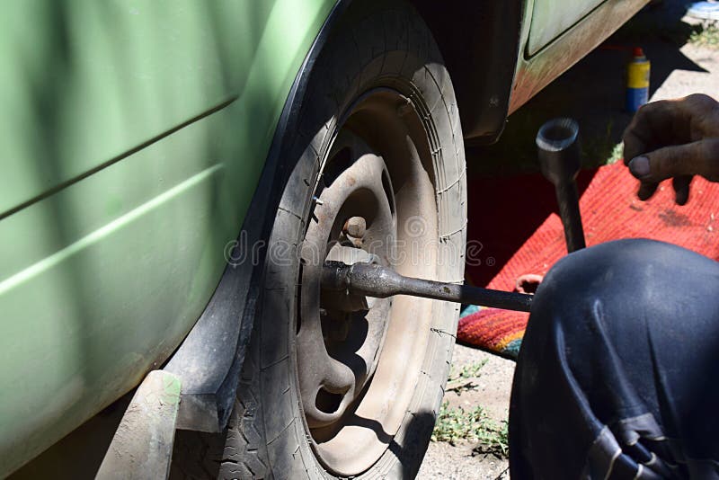 Installing a Wheel on an Old Car Stock Image - Image of black ...