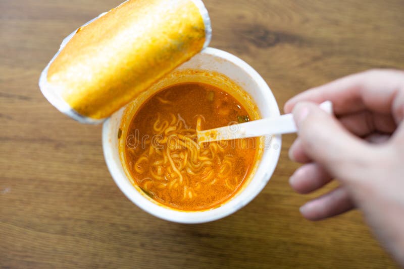 Instant Noodles in a Round Cup are Stirred with a Plastic Fork. Brewing ...