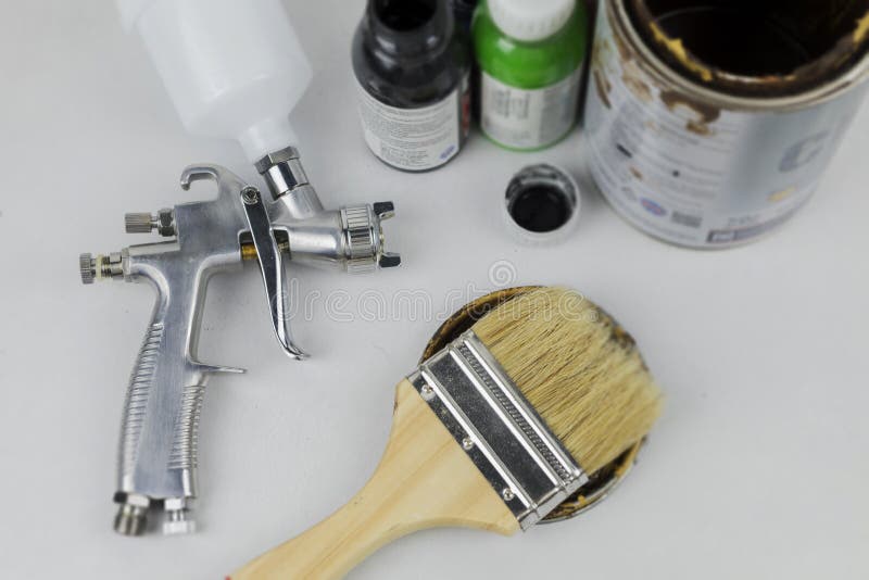 Instructions and a Paint Spray Gun at Work at the Workplace in the ...