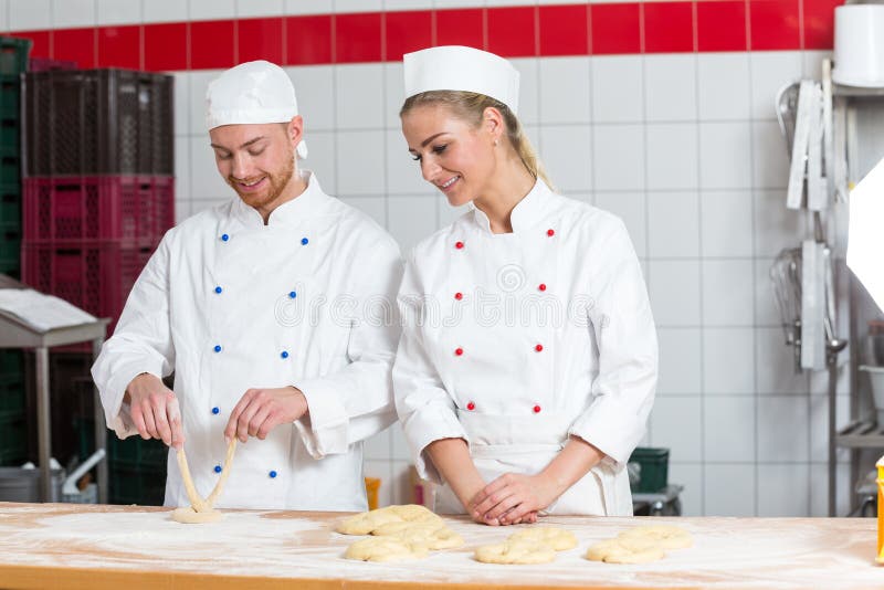 Instructor and Apprentice in Bakery Making Pretzels Stock Image - Image ...