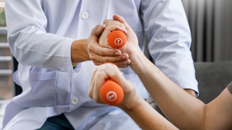 Instructor Assisting Senior Doing Exercise Working Out in Clinic ...