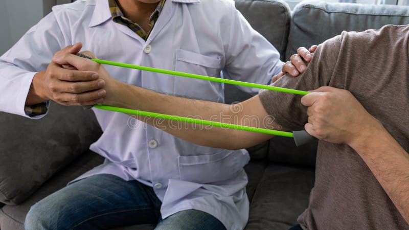 Instructor Assisting Senior Doing Exercise Working Out in Clinic ...