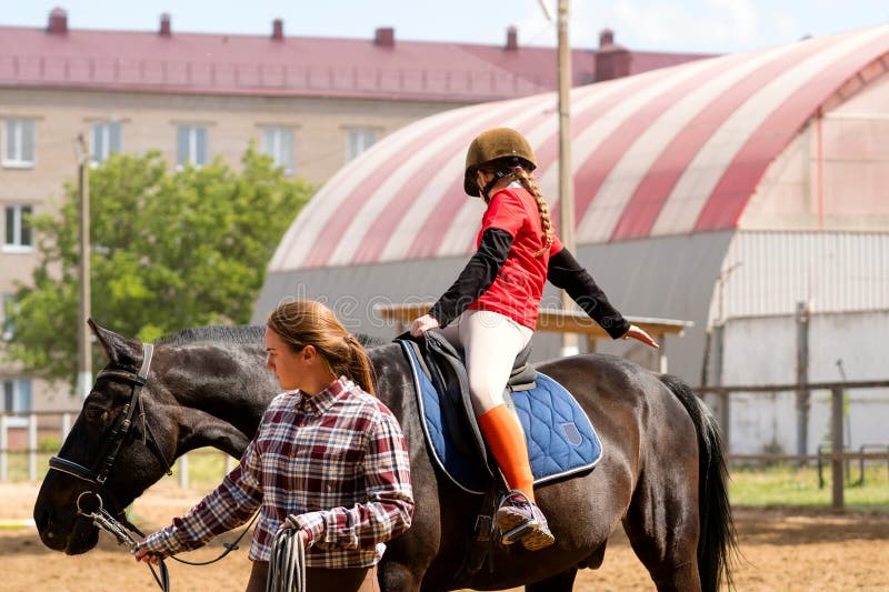 Instructor Assists Young Rider during Outdoor Equestrian Session Stock ...