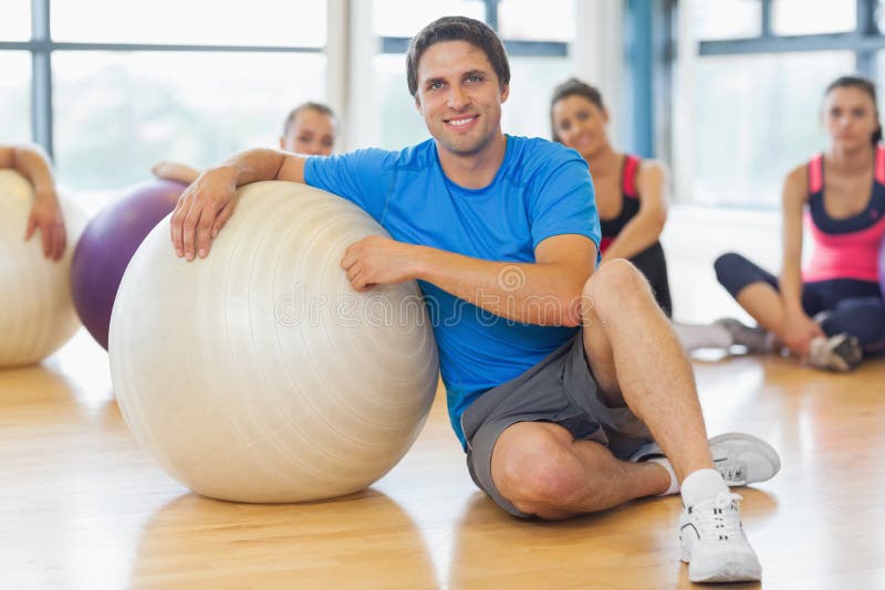 Instructor and Fitness Class with Exercise Balls at Gym Stock Image ...
