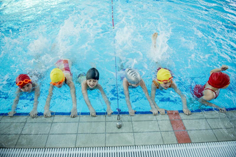 Instructor and Group of Children Doing Exercises Near a Swimming Pool ...
