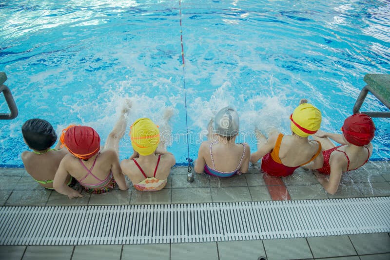 Instructor and Group of Children Doing Exercises Near a Swimming Pool ...