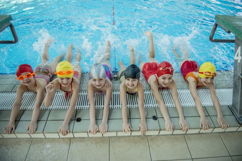 Instructor and Group of Children Doing Exercises Near a Swimming Pool ...