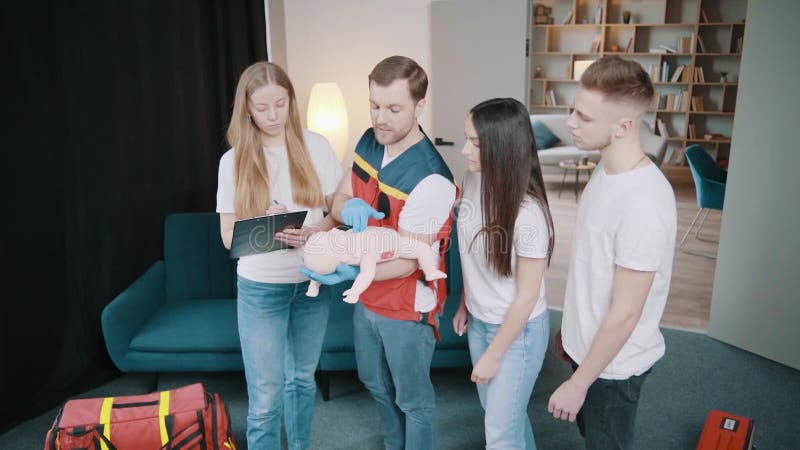 Instructor Performs CPR on Baby Training Doll. Man Instructor Show How ...