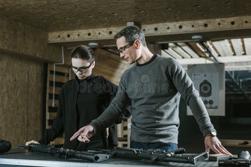 Instructor Pointing on Rifle on Table Stock Image - Image of pointingon ...