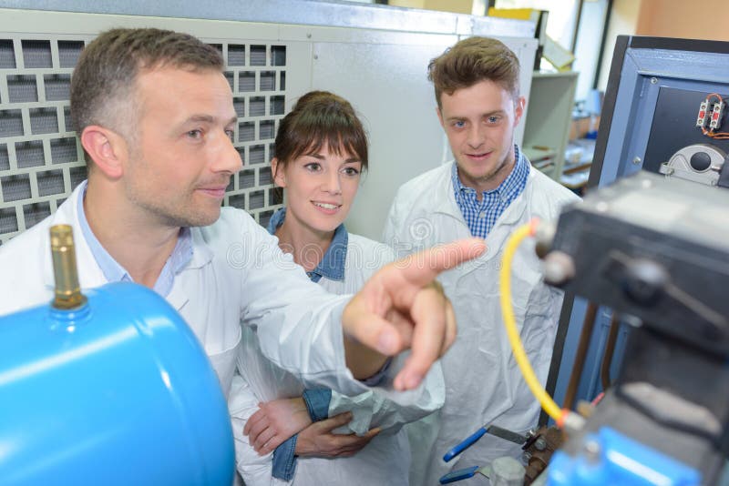 Instructor Showing Equipment To Student Engineers Stock Image - Image ...