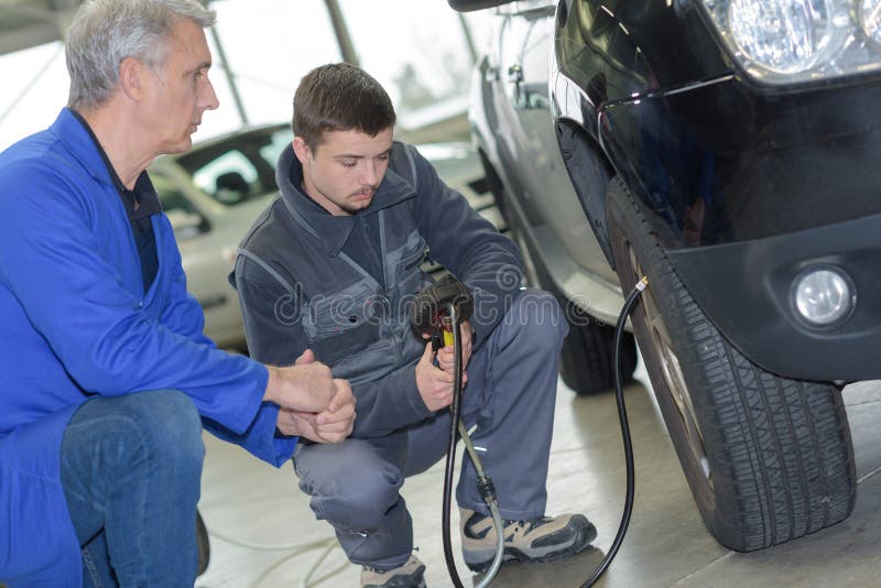 Instructor Showing Student How To Change Car Brakes Stock Image - Image ...