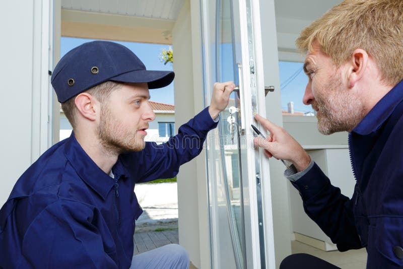 Insulated Door Installer and Apprentice Stock Image - Image of contract ...