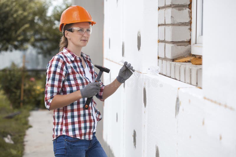 Insulation of the House with Polyfoam. the Worker is Checking with the ...