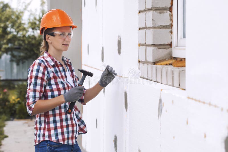 Insulation of the House with Polyfoam. the Worker is Checking with the ...