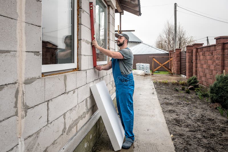 Insulation of the House with Polyfoam. the Worker is Checking the Wall ...