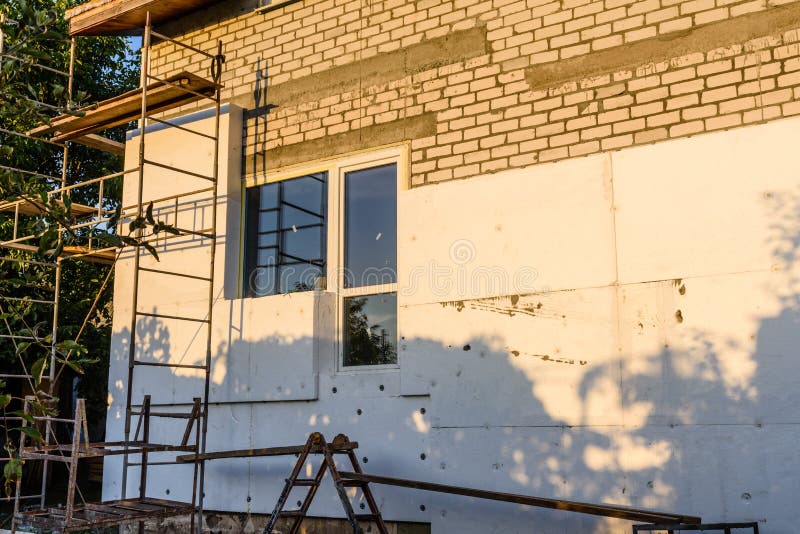 Insulation of the House with Styrofoam. Scaffold on Building Stock ...