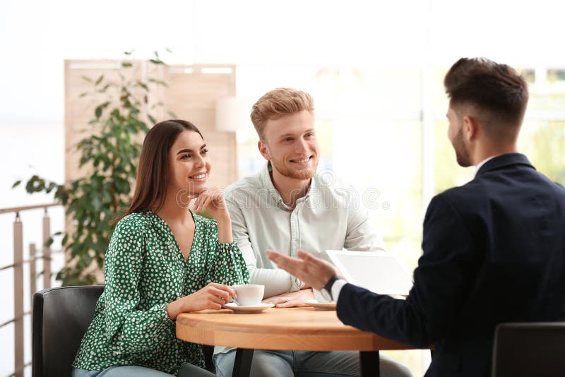 Insurance Agent Working with Young Couple Stock Photo - Image of ...