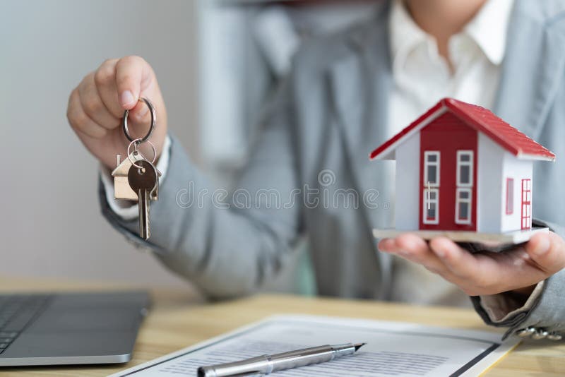 Insurance Concept the Real Estate Representative Holding a House Key on ...
