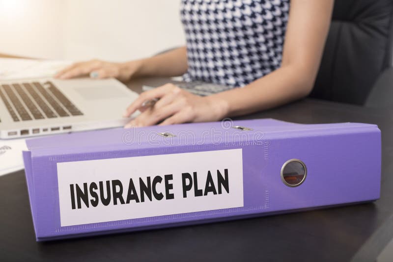 Insurance Plan Folder and Agent Working on Computer on Desk Stock Photo ...