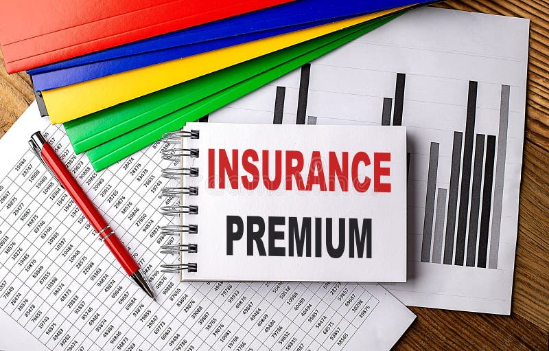 INSURANCE PREMIUM Text on Notebook with Pen, Folder on a Chart ...