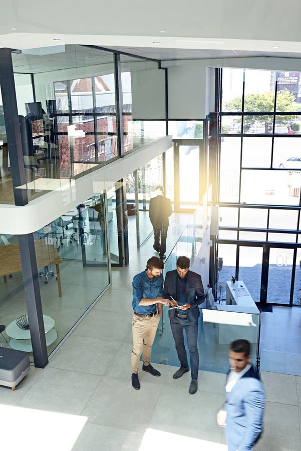 Integrating Digital Workflow into Their Day. Two Colleagues Talking ...