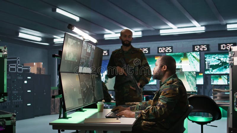 Intelligence Corps Agent Checking Screens, Discussing with Colleague ...