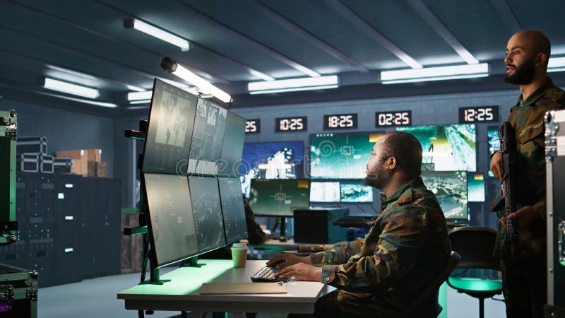 Intelligence Corps Agent Checking Screens, Discussing with Colleague ...