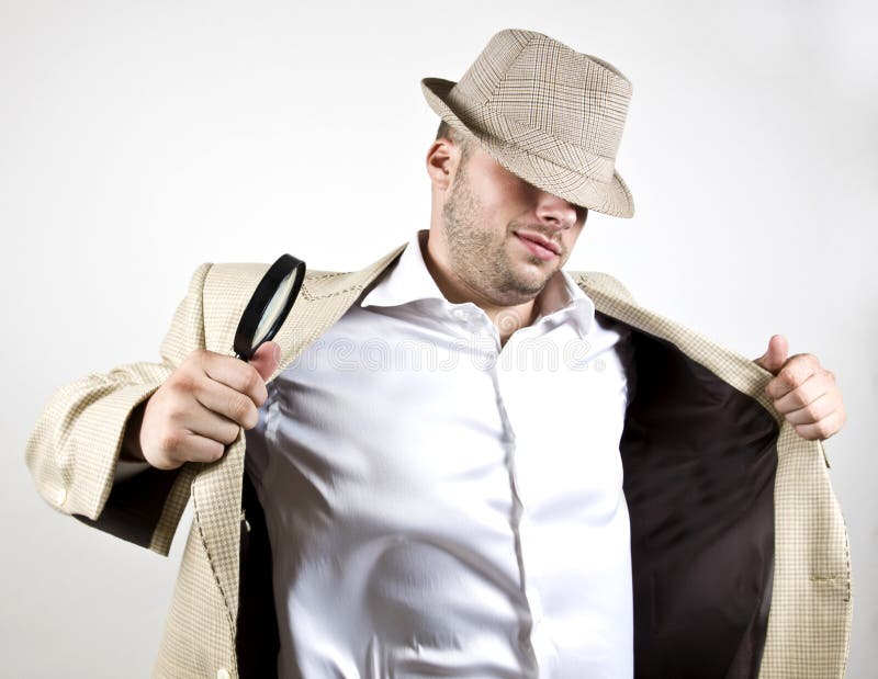 Sherlock: Detective Using Magnifying Glass To Examine Something Stock ...