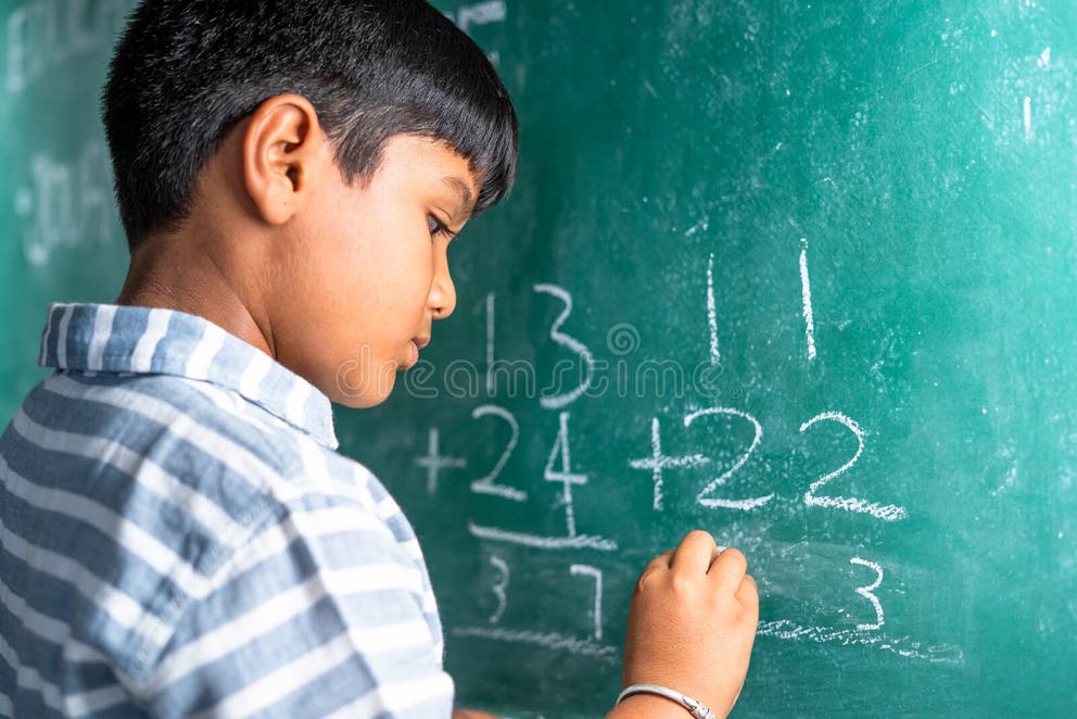 Intelligent Elementary School Kid Solving Maths Problem on Chalkboard ...