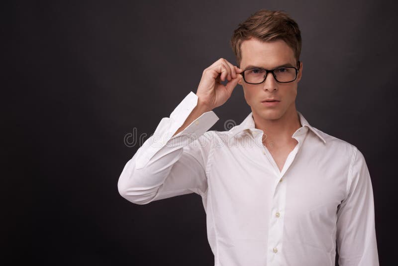 Intelligent and Handsome. a Handsome Young Man Putting on His Glasses ...