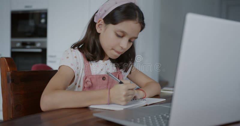 Intelligent Kid Doing Homework Using Laptop Computer and Writing Notes ...